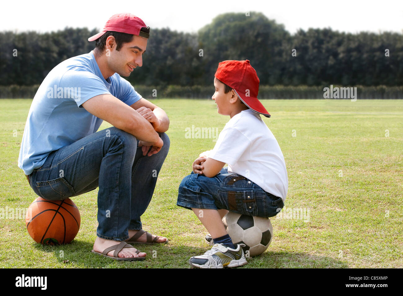 Father and son sitting face to face Stock Photo - Alamy