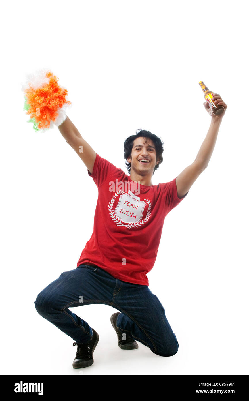 Boy with a beer bottle cheering Stock Photo - Alamy