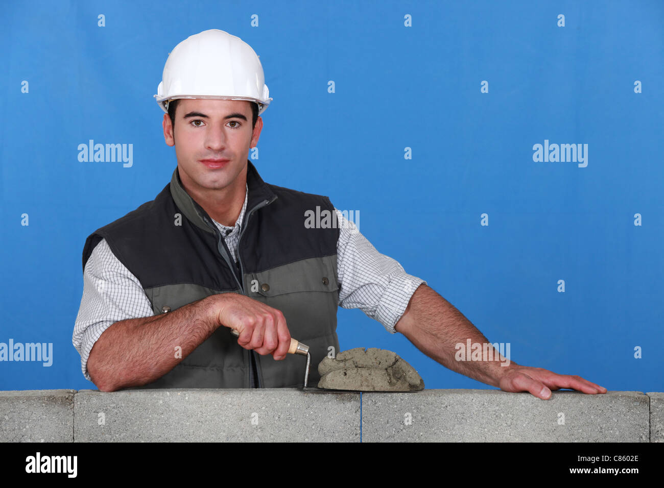 Man building wall Stock Photo - Alamy