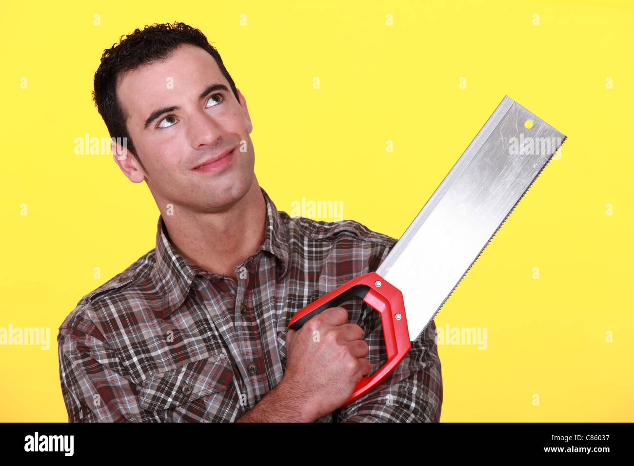 Smiling man with a tenon saw Stock Photo - Alamy