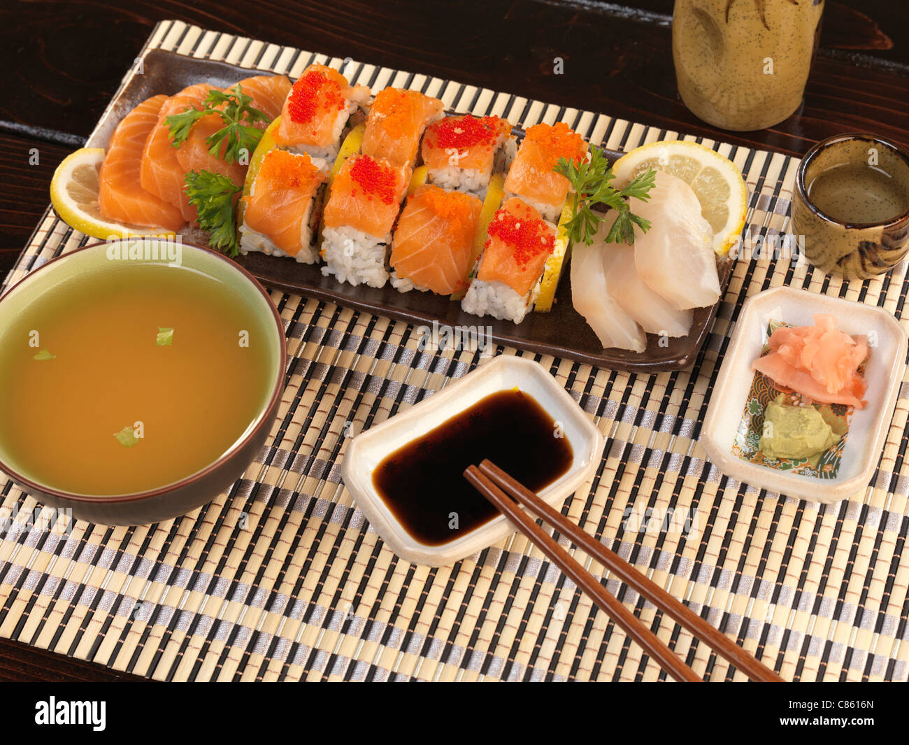 Served sushi rolls, sashimi, miso and sake Stock Photo - Alamy
