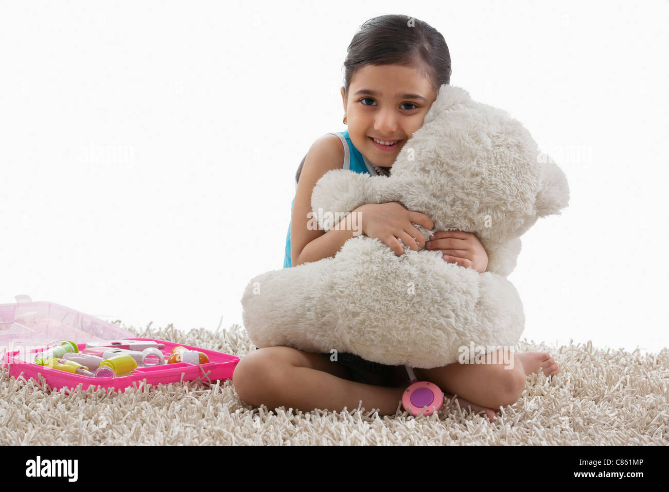 Girl hugging her teddy bear Stock Photo - Alamy