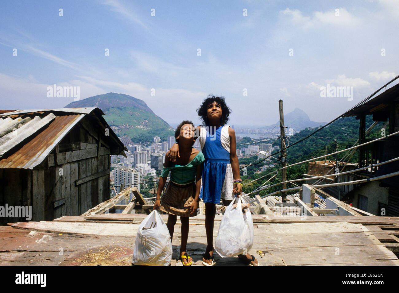 Rio de Janeiro, Brazil. Favela shanty town; two poor children from a ...