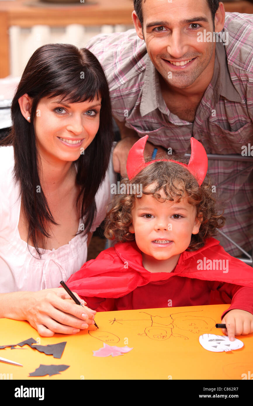 parents and a little boy dressed in devil Stock Photo - Alamy