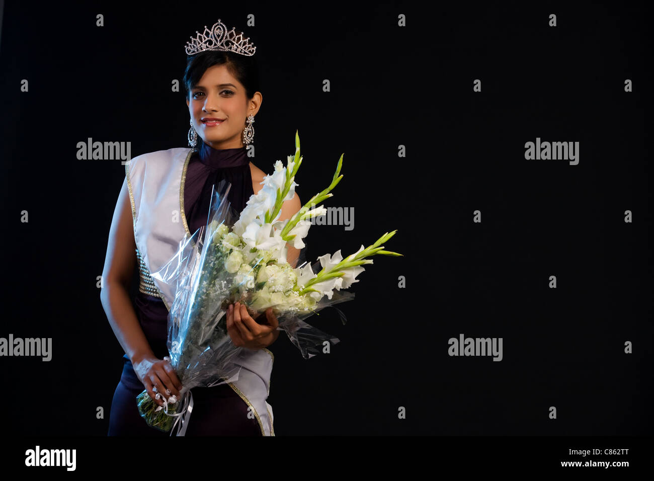 Portrait of a beauty queen with a bouquet Stock Photo - Alamy