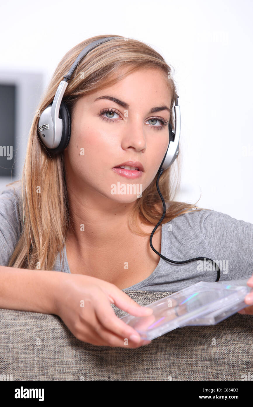 Young woman listening to CDs Stock Photo - Alamy