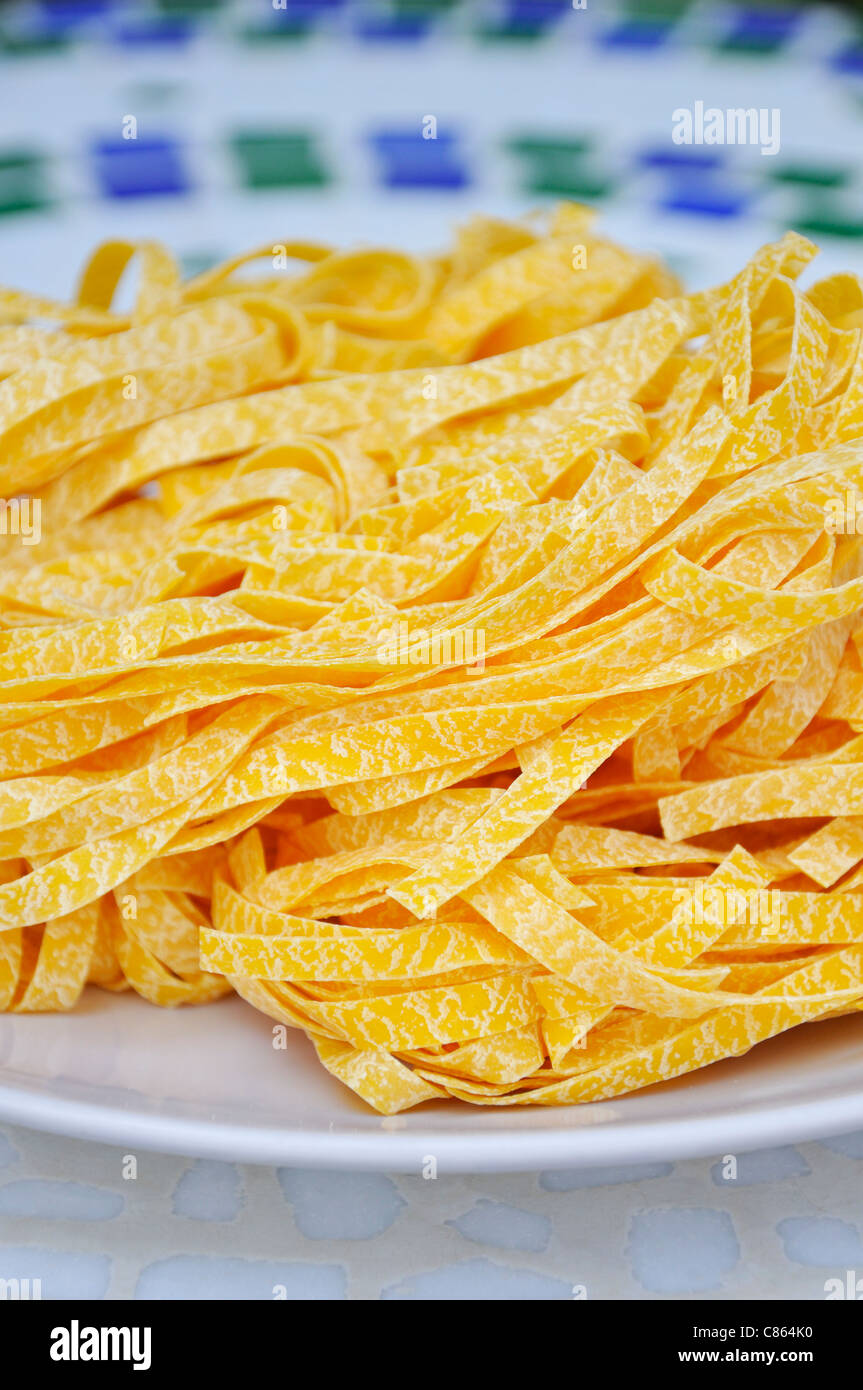 Dry egg pasta ready to be cooked Stock Photo - Alamy