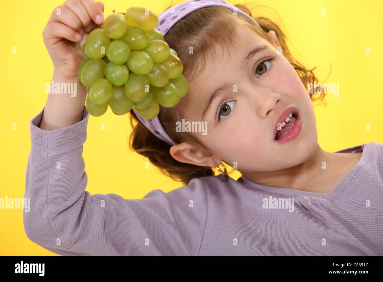 Little girl eating grapes Stock Photo - Alamy