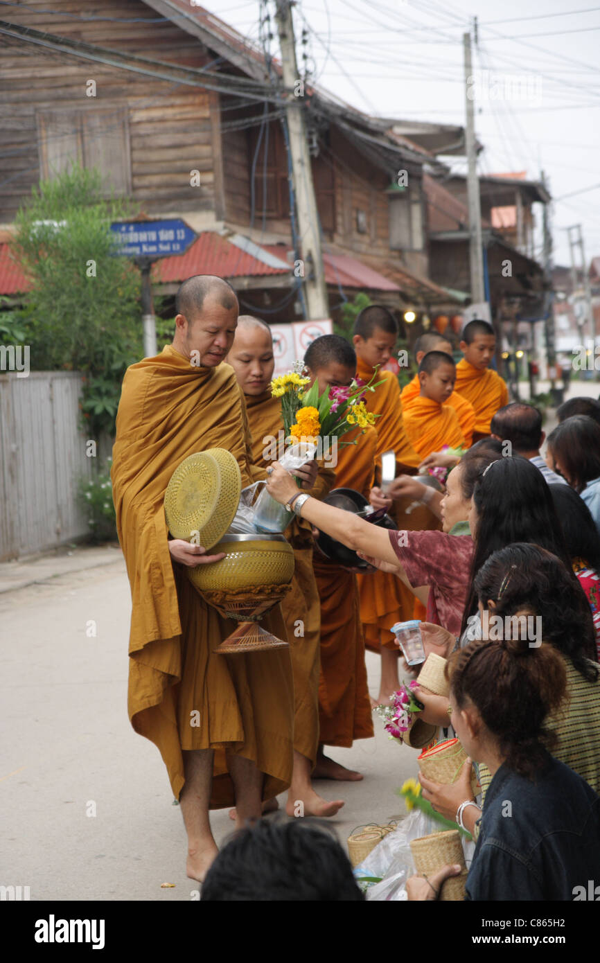 People give food offerings food to a Buddhist monk at Chiangkhan ...
