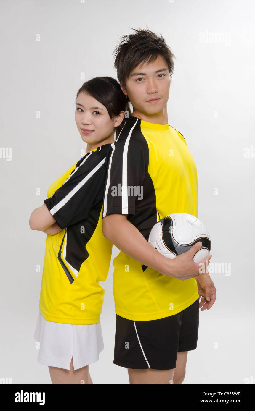 young couple as football players Stock Photo - Alamy