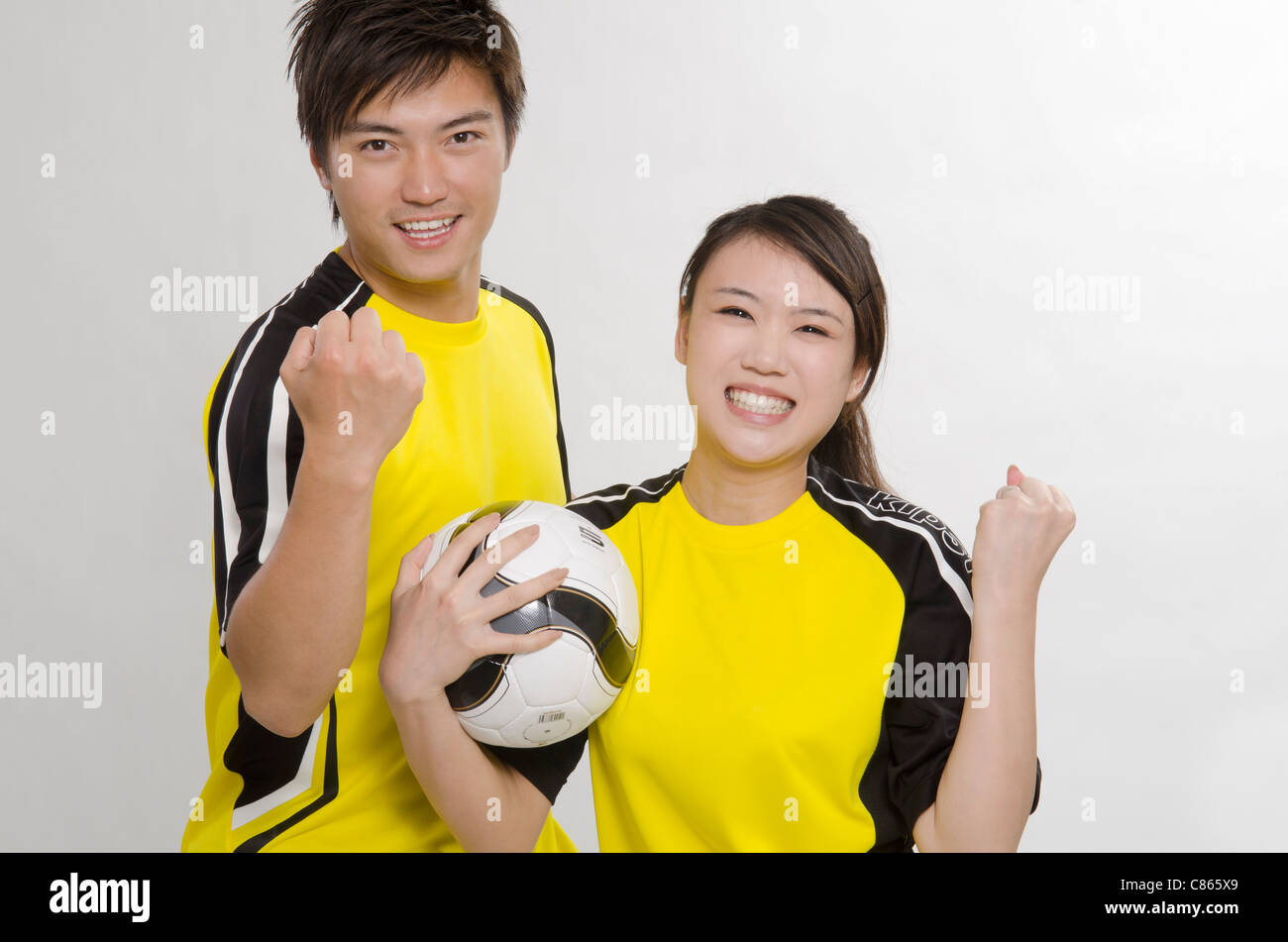 young couple as football players Stock Photo - Alamy