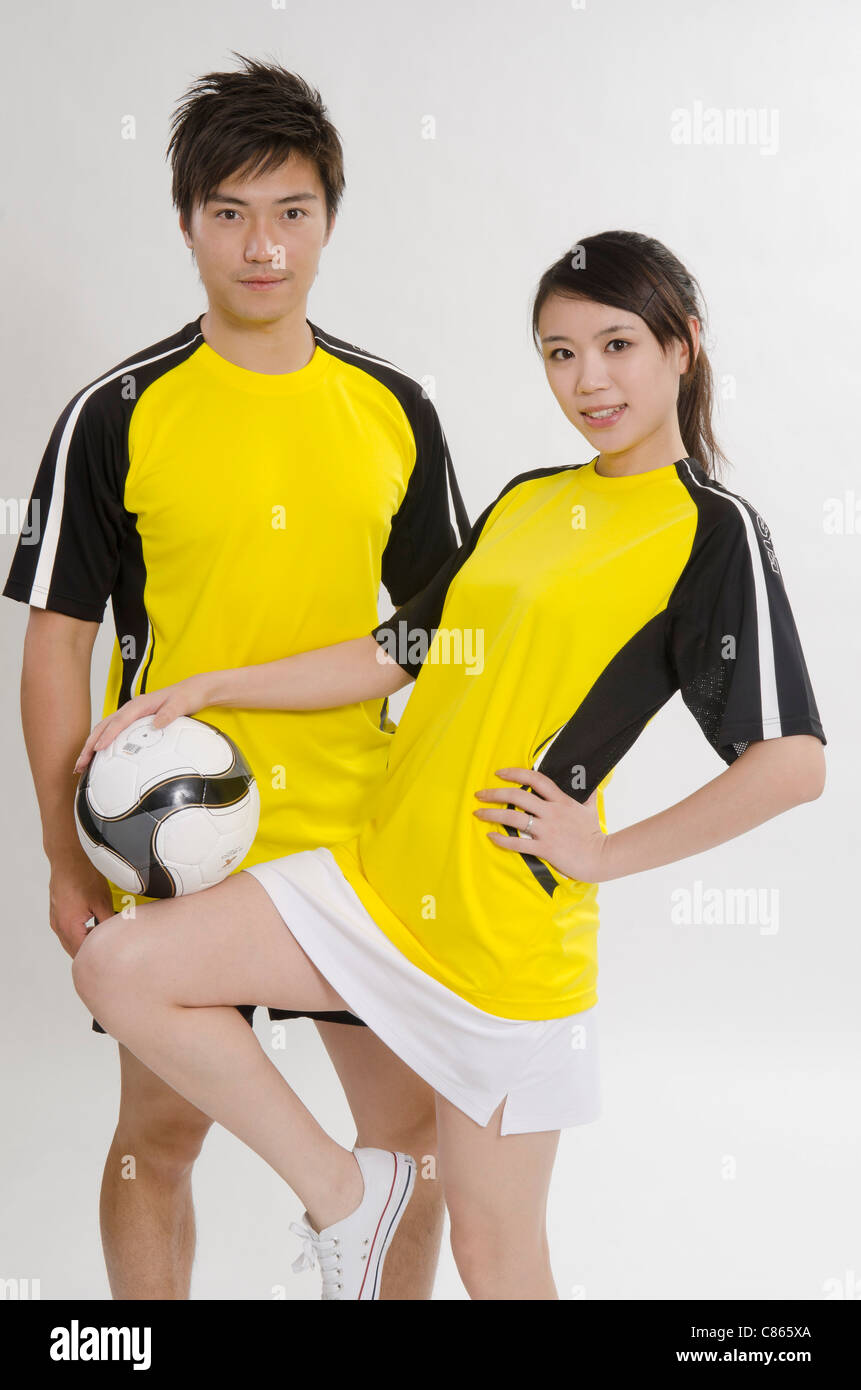 young couple as football players Stock Photo - Alamy