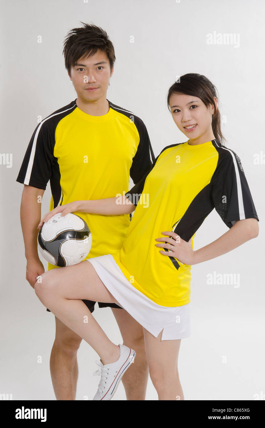 young couple as football players Stock Photo - Alamy