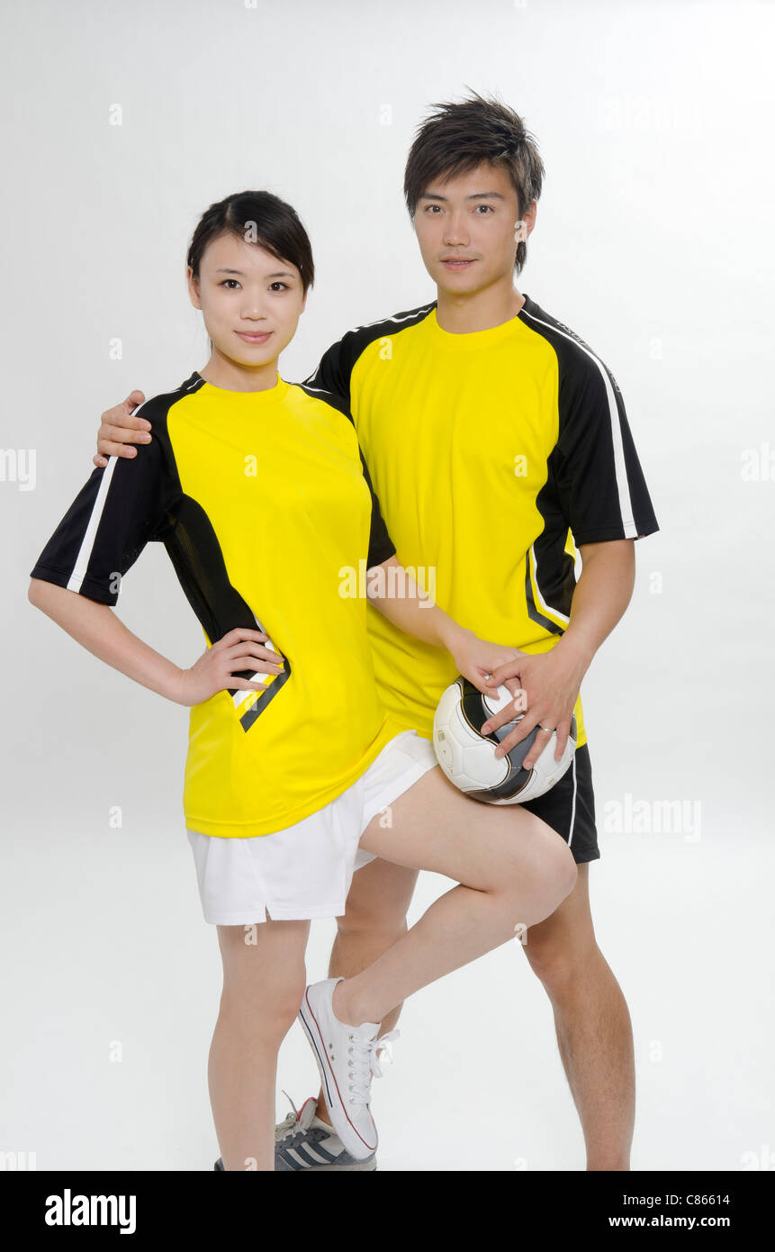 Young Couple football players Stock Photo - Alamy