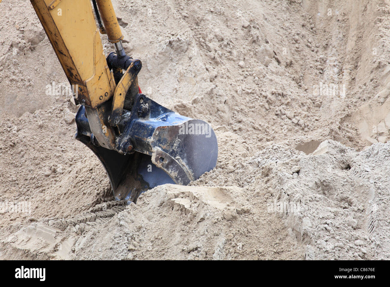 bucket digger of an earthmover on sand background Stock Photo - Alamy