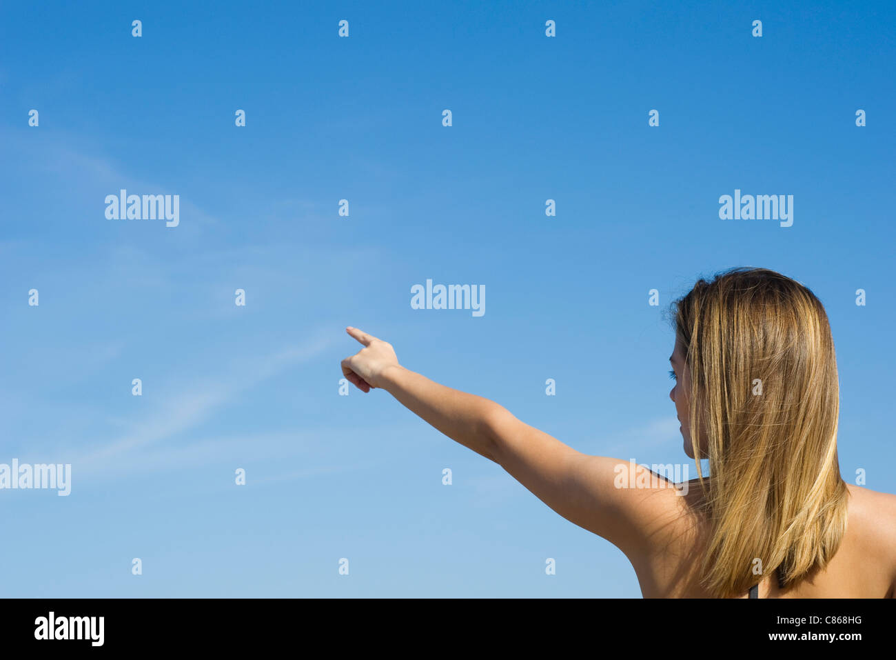 Woman pointing at the sky, rear view Stock Photo - Alamy