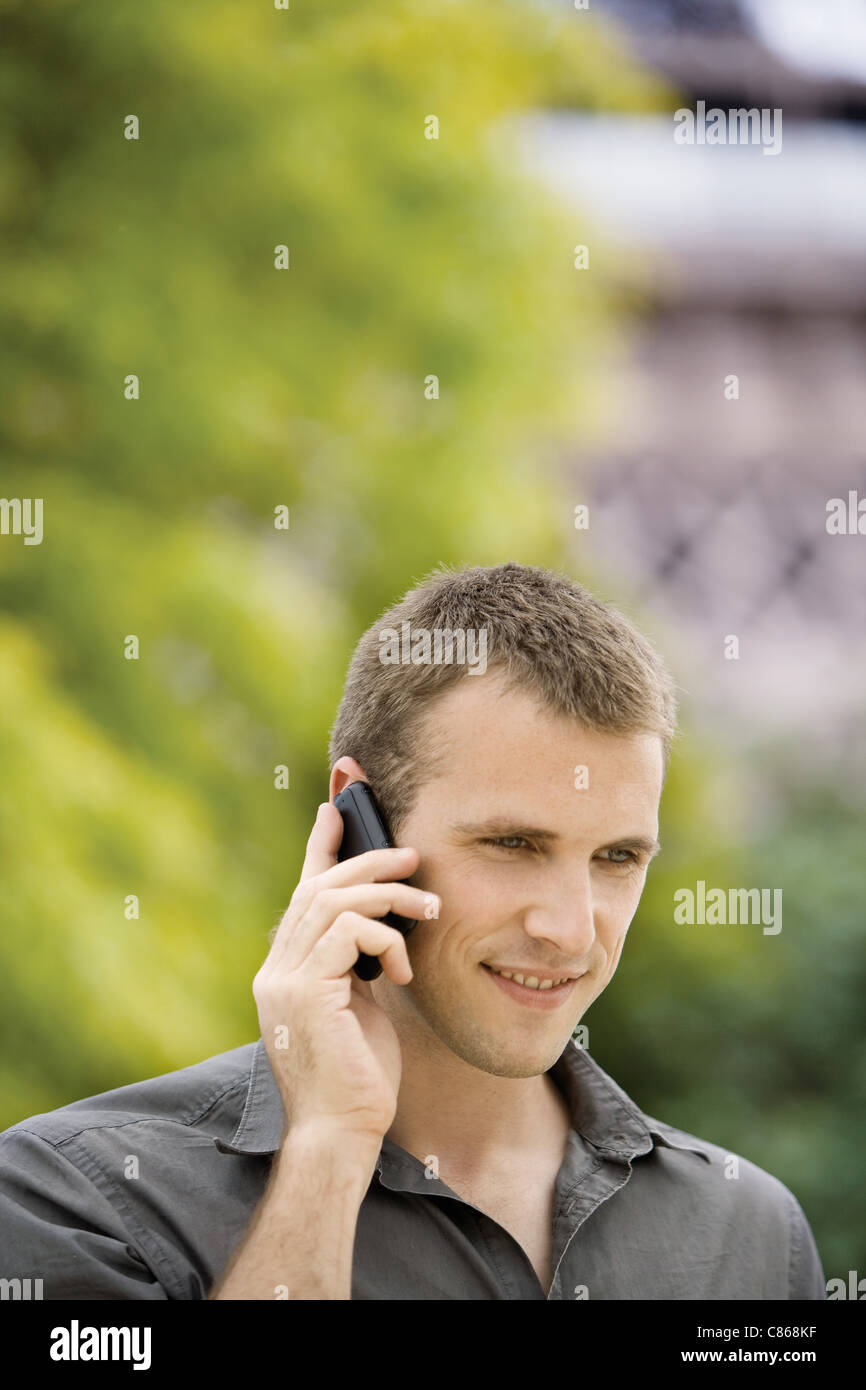 Man using cell phone outdoors Stock Photo - Alamy