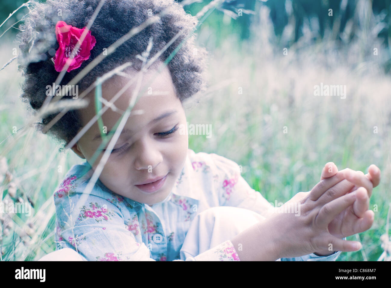 Little girl playing outdoors Stock Photo - Alamy