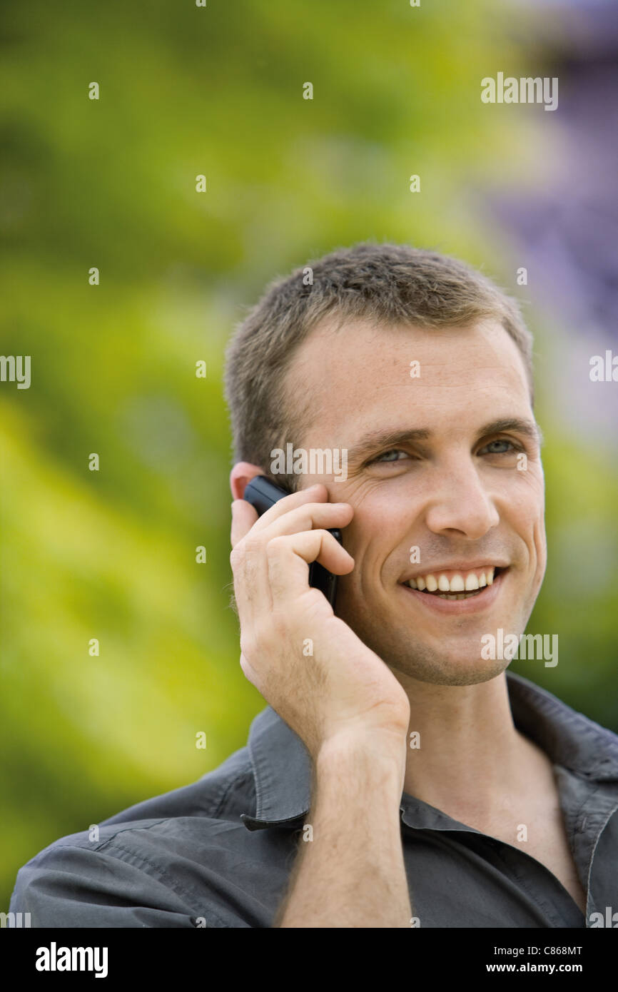 Man using cell phone outdoors Stock Photo - Alamy
