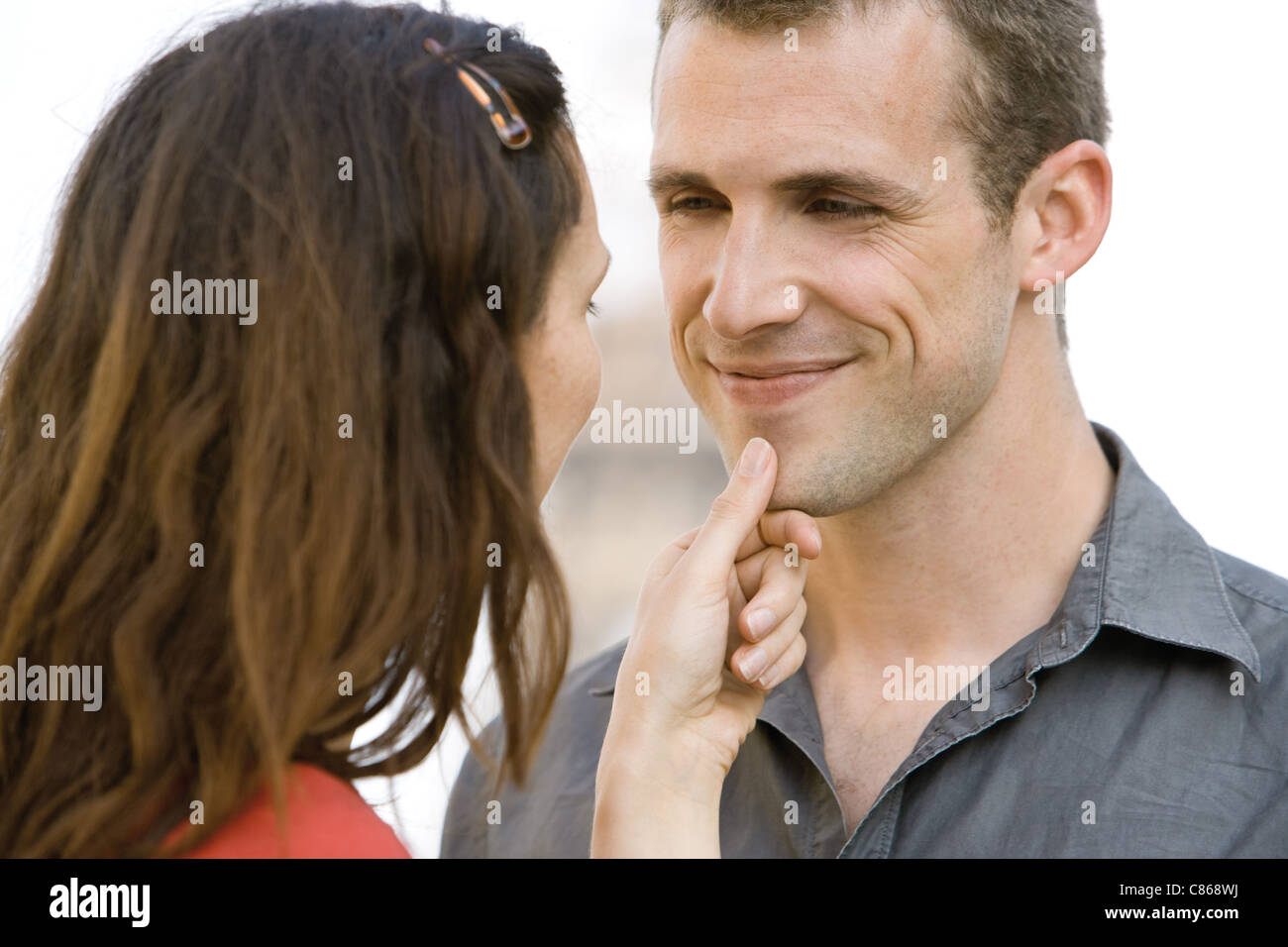Woman caressing man's chin Stock Photo - Alamy