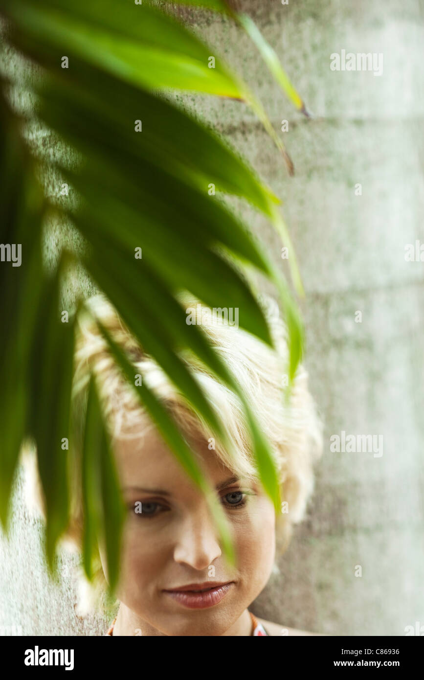 Woman relaxing under palm tree Stock Photo - Alamy