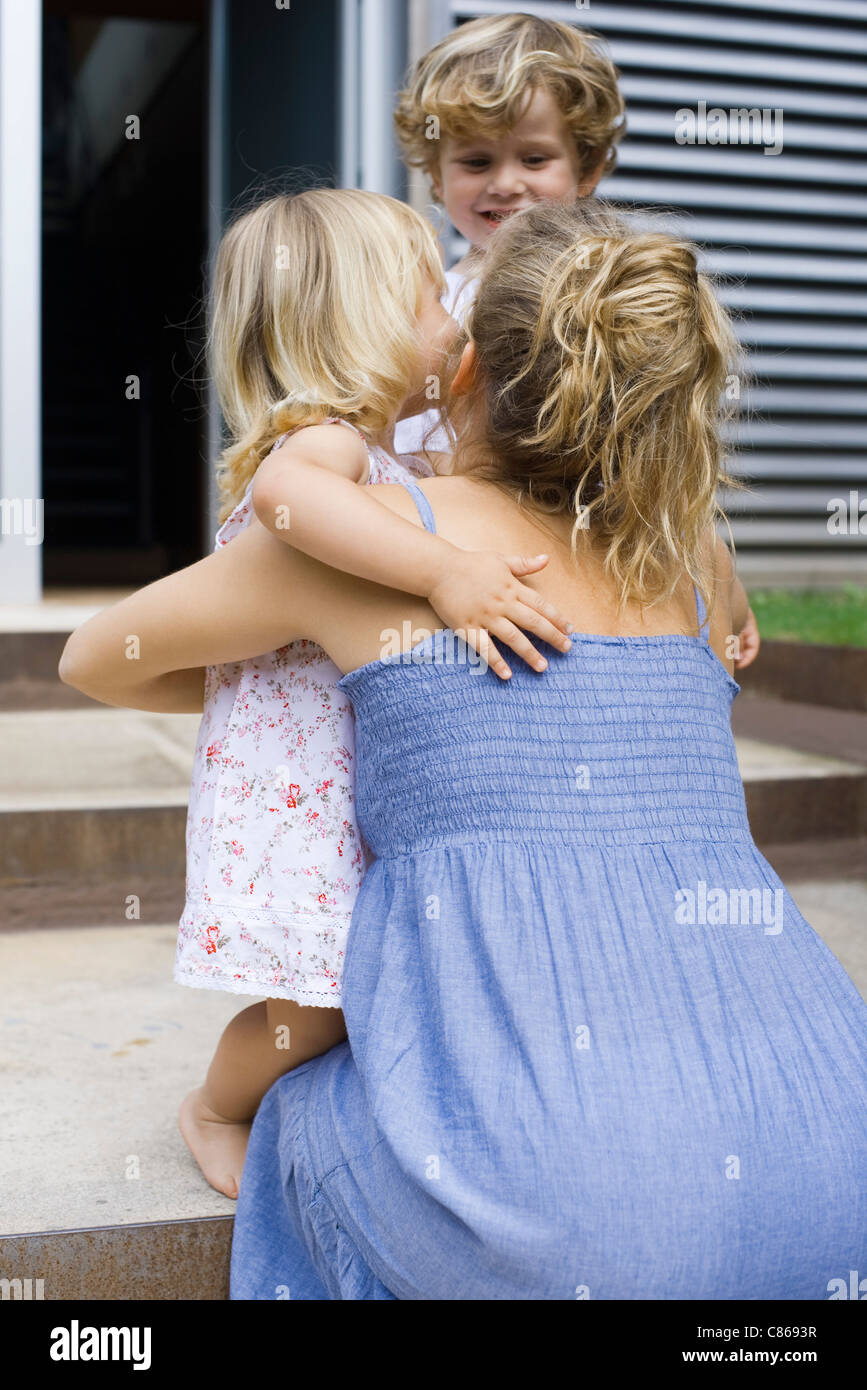 Rear view of parents hugging child hi-res stock photography and images ...