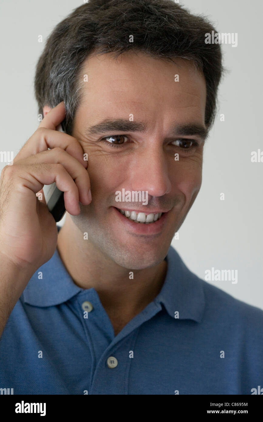 Man using cell phone, smiling Stock Photo - Alamy