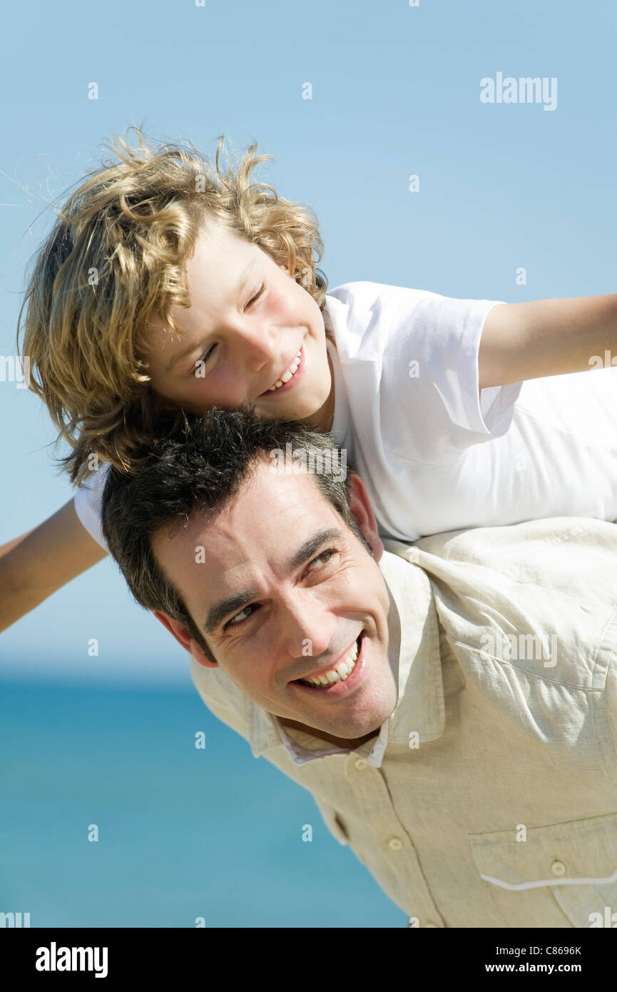 Father giving son piggback ride outdoors Stock Photo - Alamy