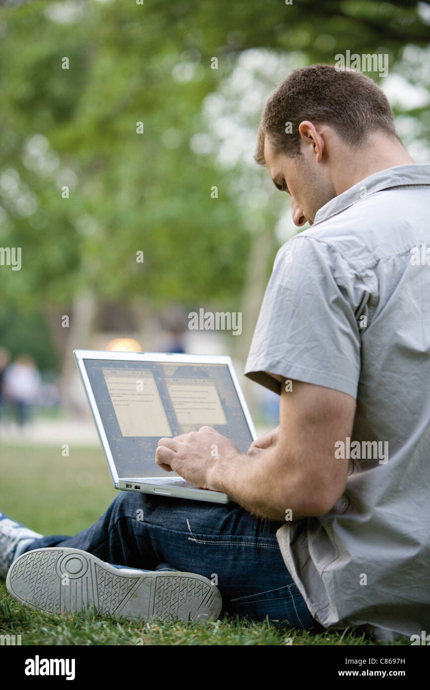 Man using laptop computer outdoors Stock Photo - Alamy