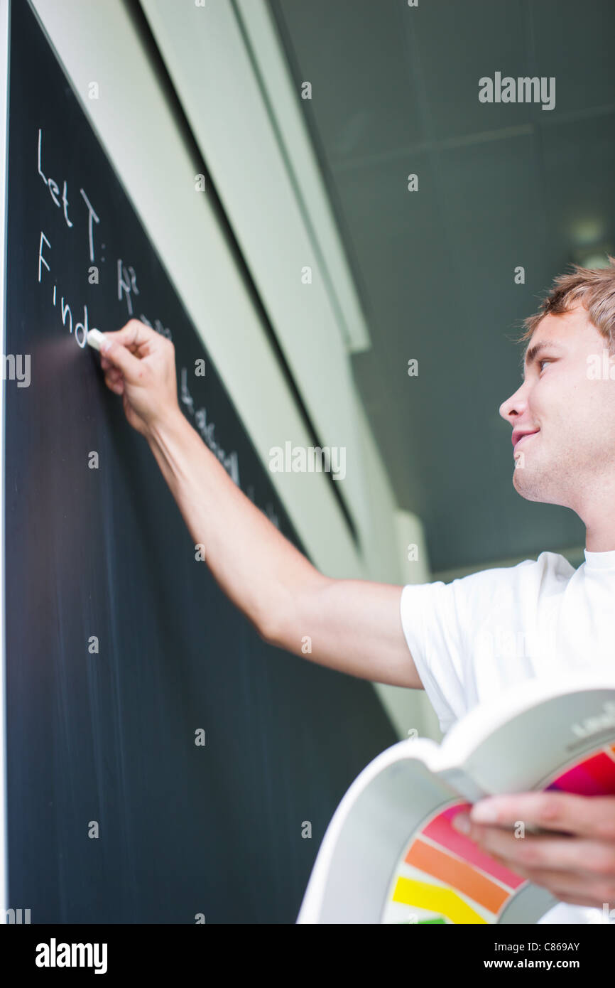 Handsome male college student writing on blackboard/chalkboard (color ...