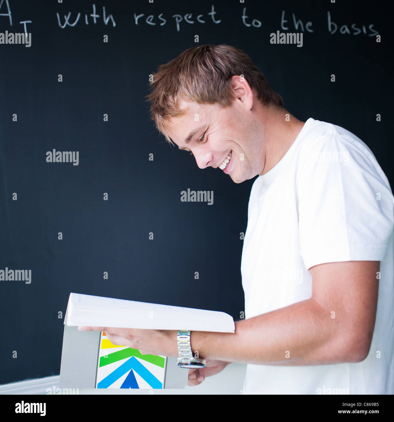 Handsome male college student writing on blackboard/chalkboard (color ...