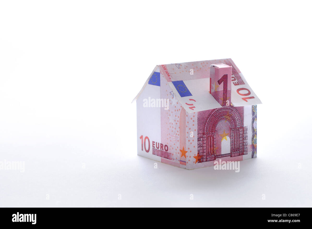 Model house folded with euro banknote Stock Photo - Alamy