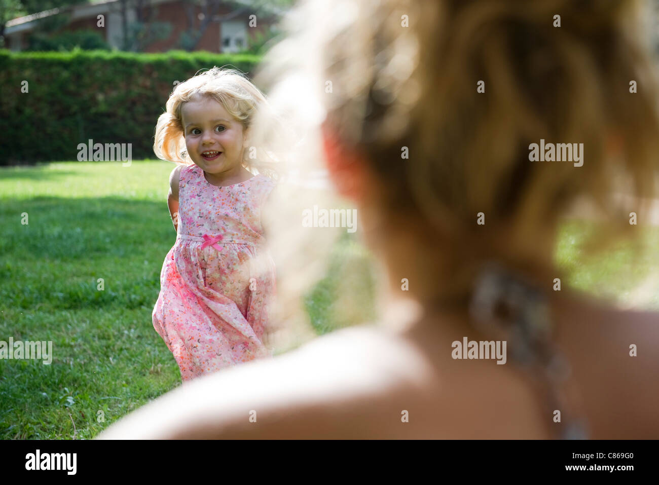 Little girl running toward mother Stock Photo - Alamy