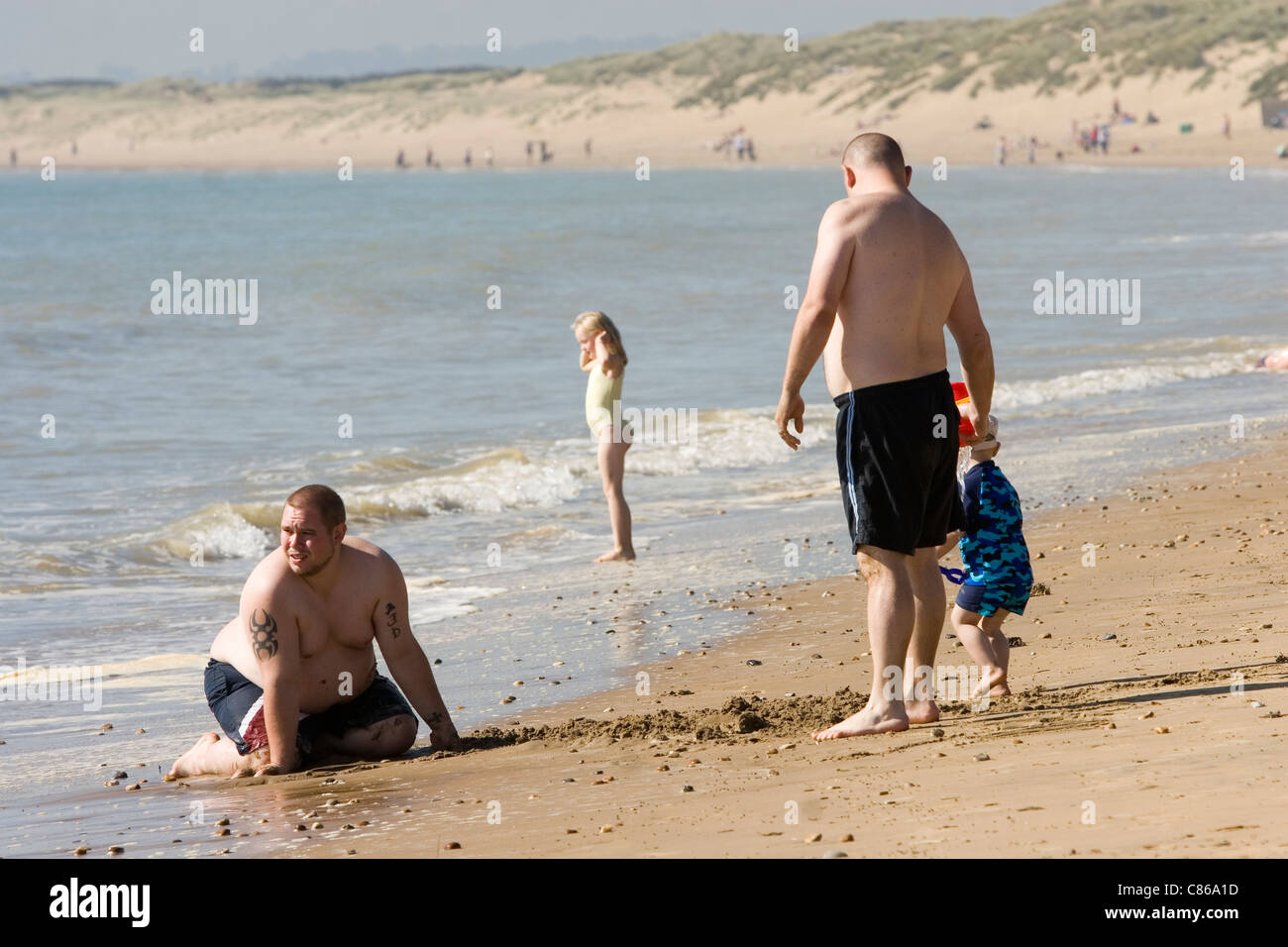 Fat man sunbathing on beach hi-res stock photography and images - Alamy