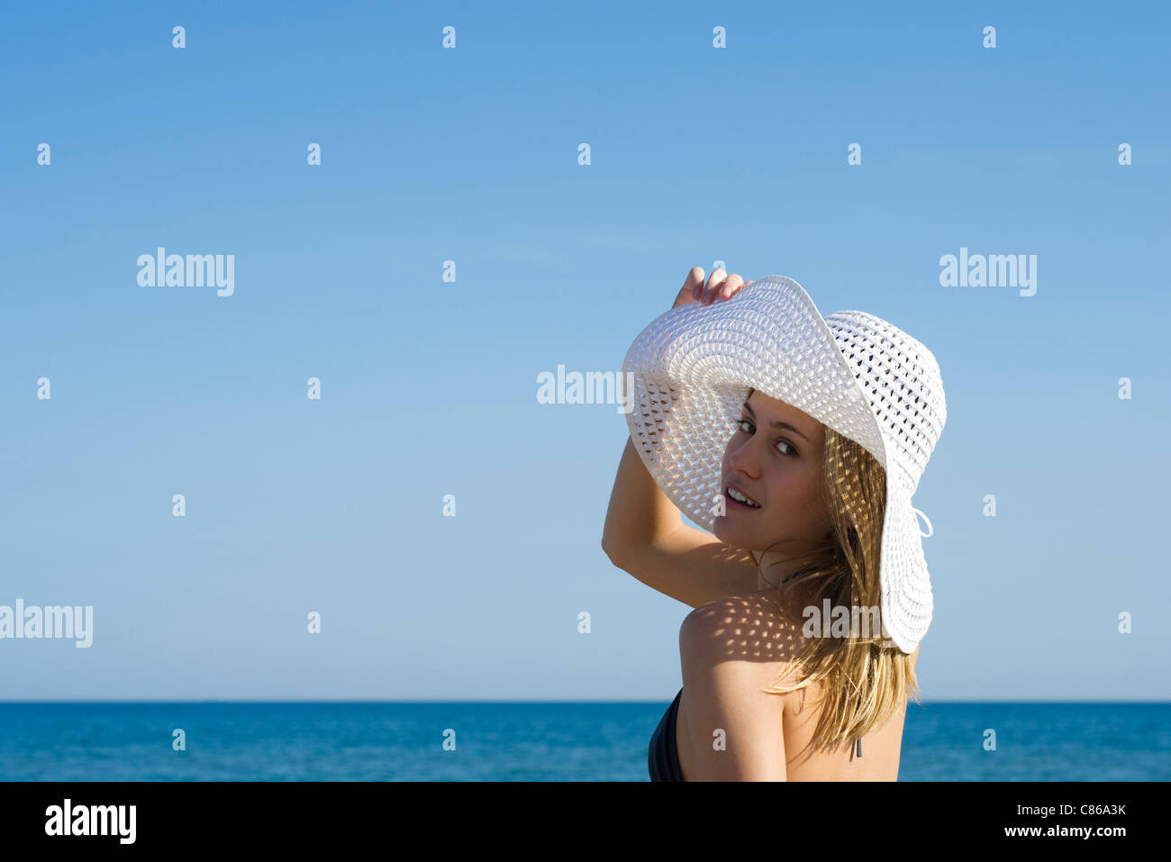 Back view of woman wearing straw hat looking at view hi-res stock photography and images - Alamy