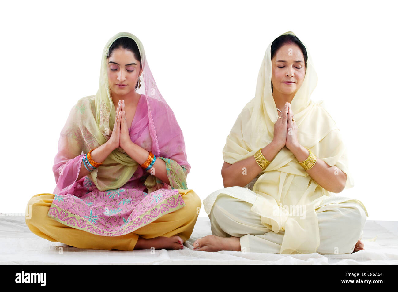 Mother and daughter praying Stock Photo - Alamy