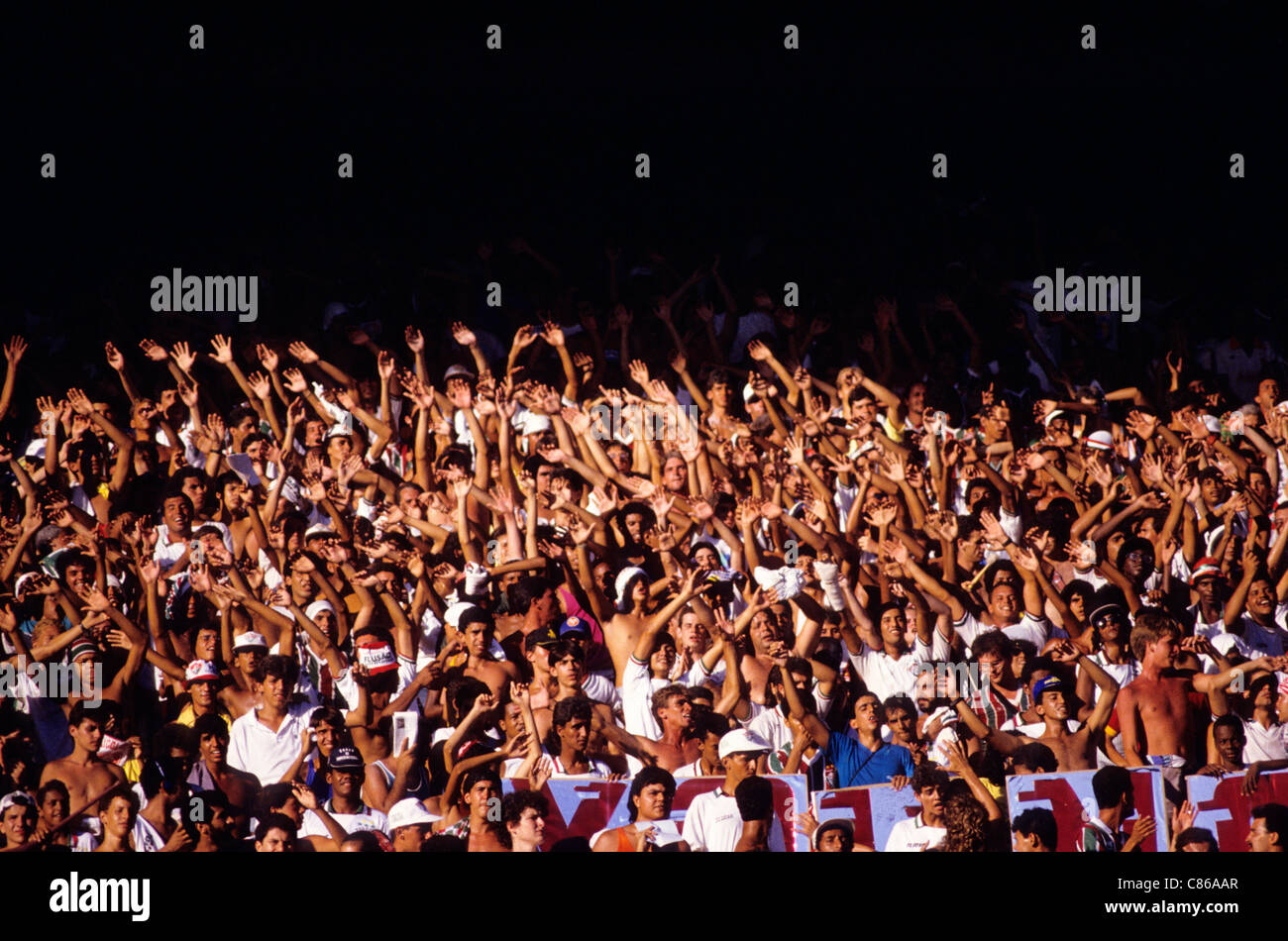 Rio de Janeiro, Brazil. Crowd of football supporters waving at a match ...