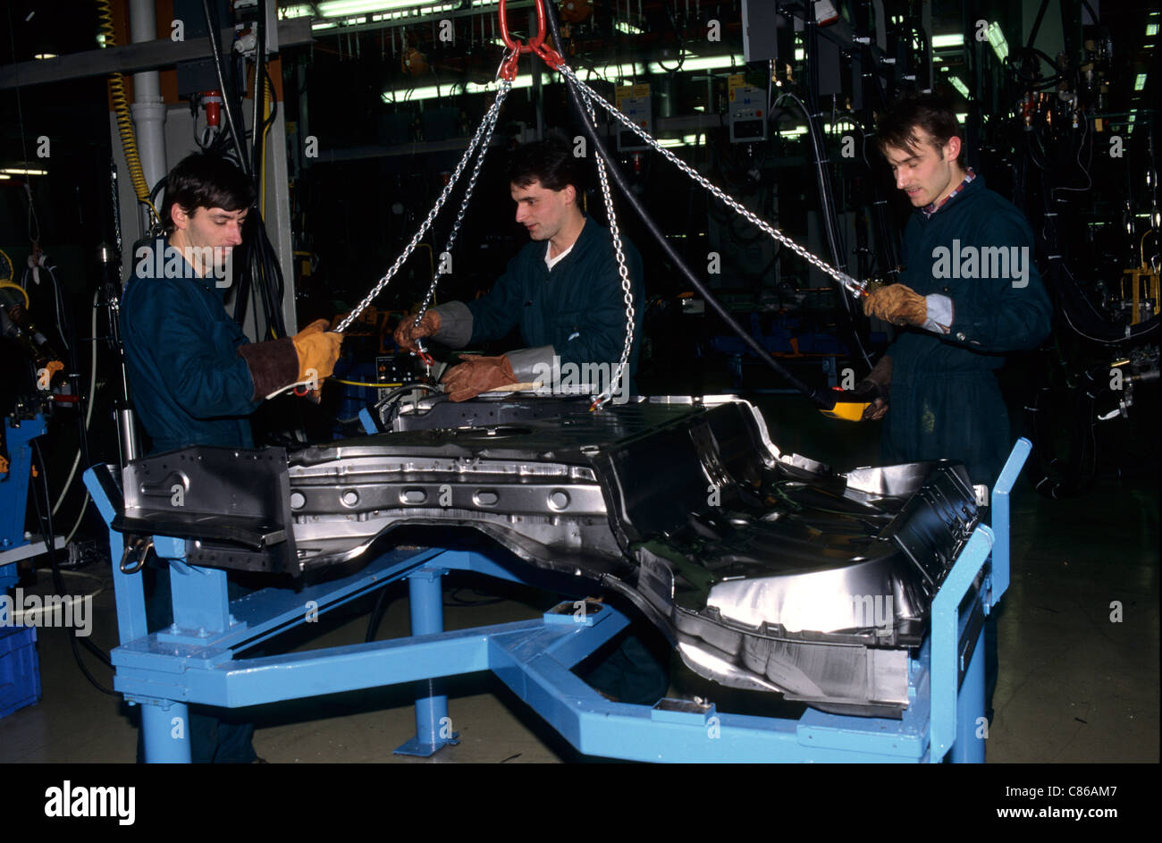 Bratislava, Slovakia: Volkswagen factory; three workers positioning a ...