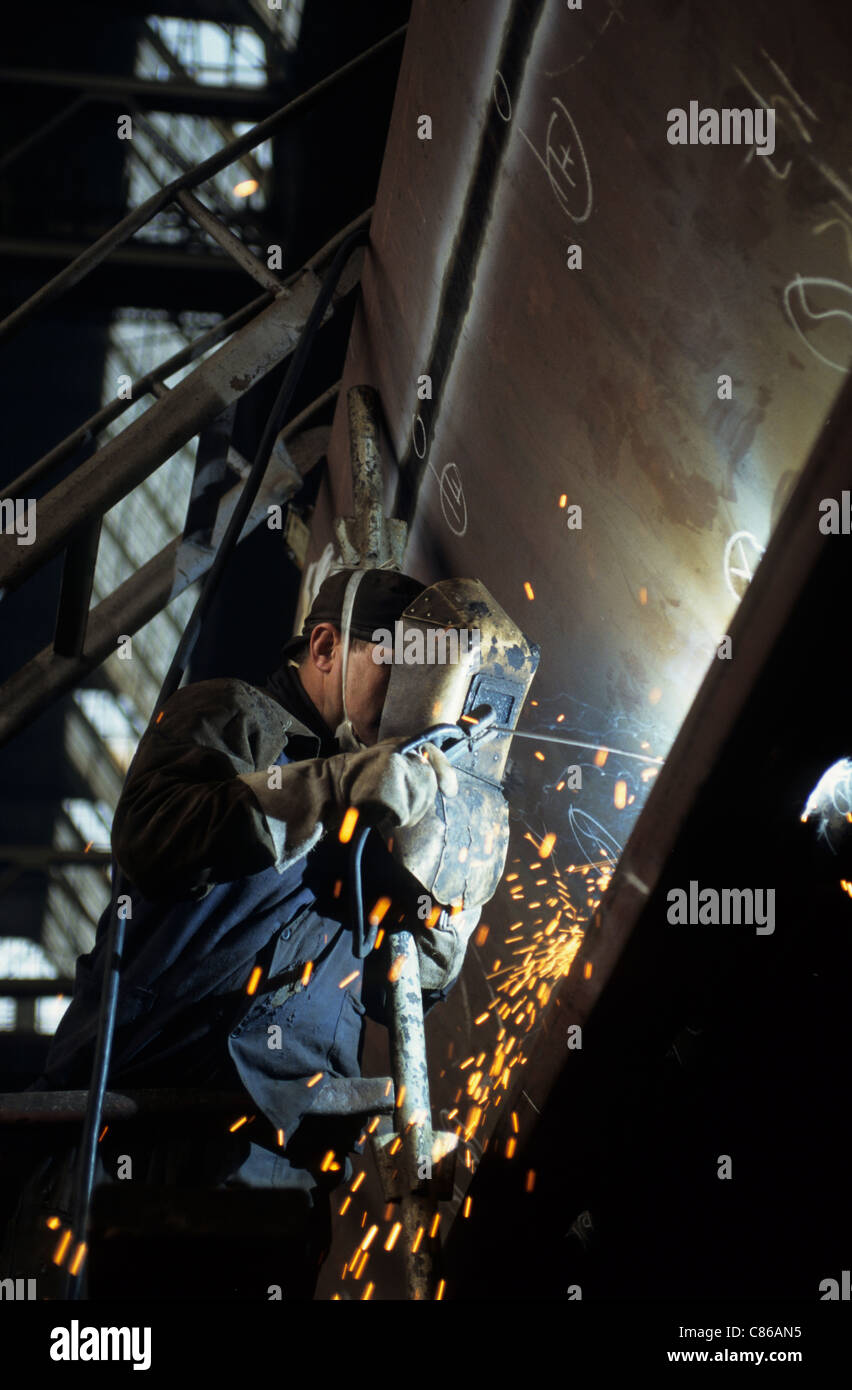 Gdansk, Poland. Shipyard worker welding with electric arc welder and ... Gdansk, Poland. Shipyard worker welding with electric arc welder and ...