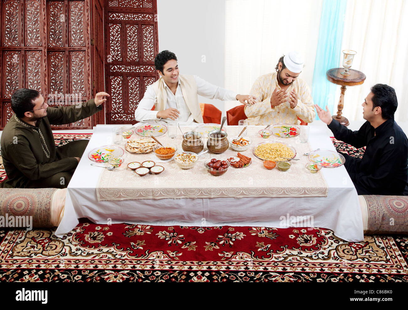 Muslim men enjoying themselves during Id Stock Photo - Alamy