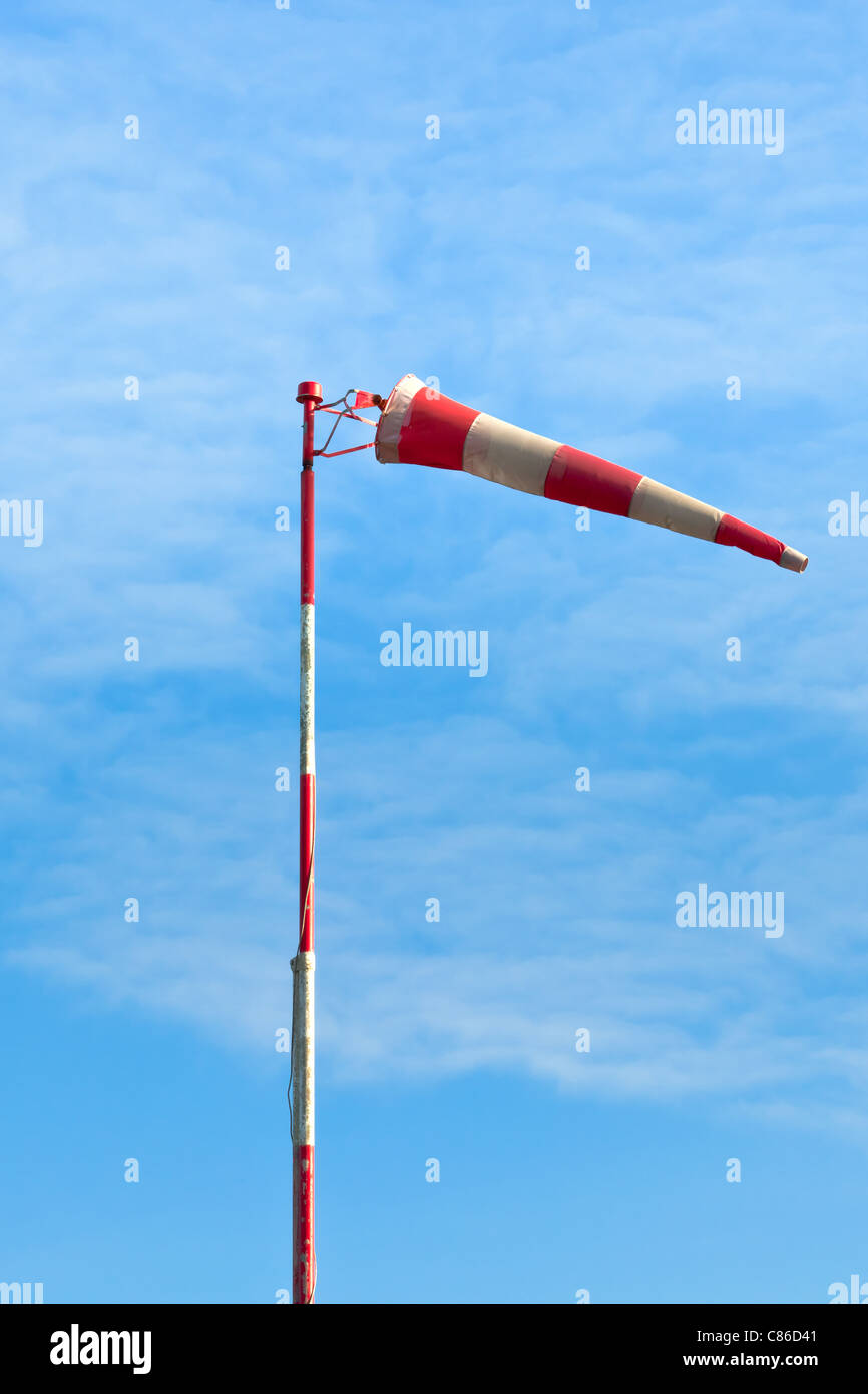 Red and white windsock against a bright blue sky Stock Photo - Alamy