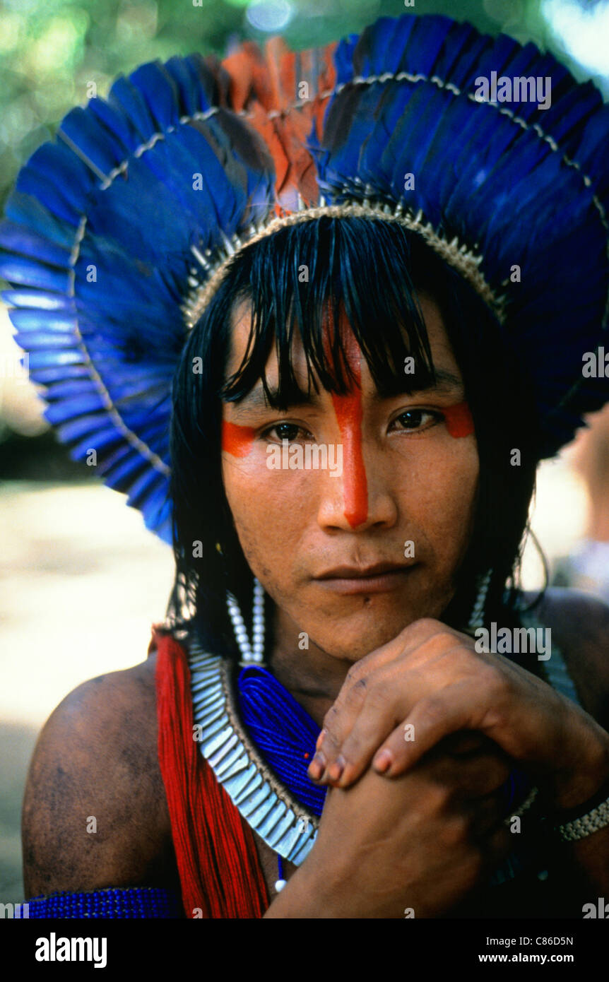 Altamira, Brazil. Ta'Kire Kayapo; warrior wearing bright blue feather ...