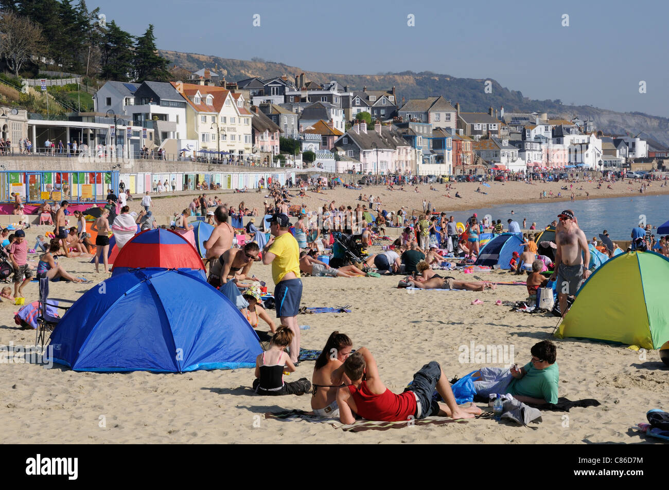 Crowded beach scene at Lyme Regis a Dorset England seaside resort on ...