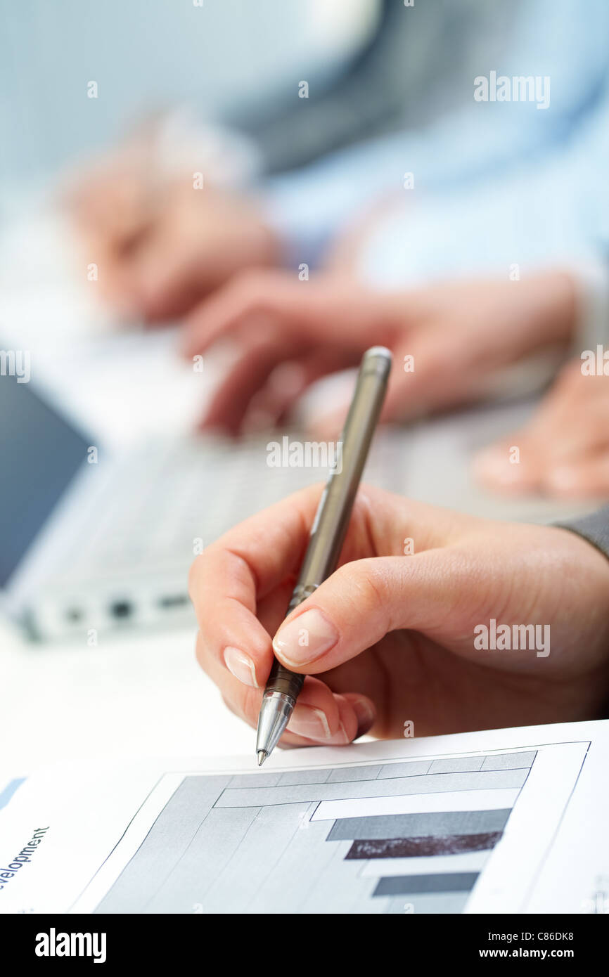 Close-up of female hands working with document Stock Photo - Alamy
