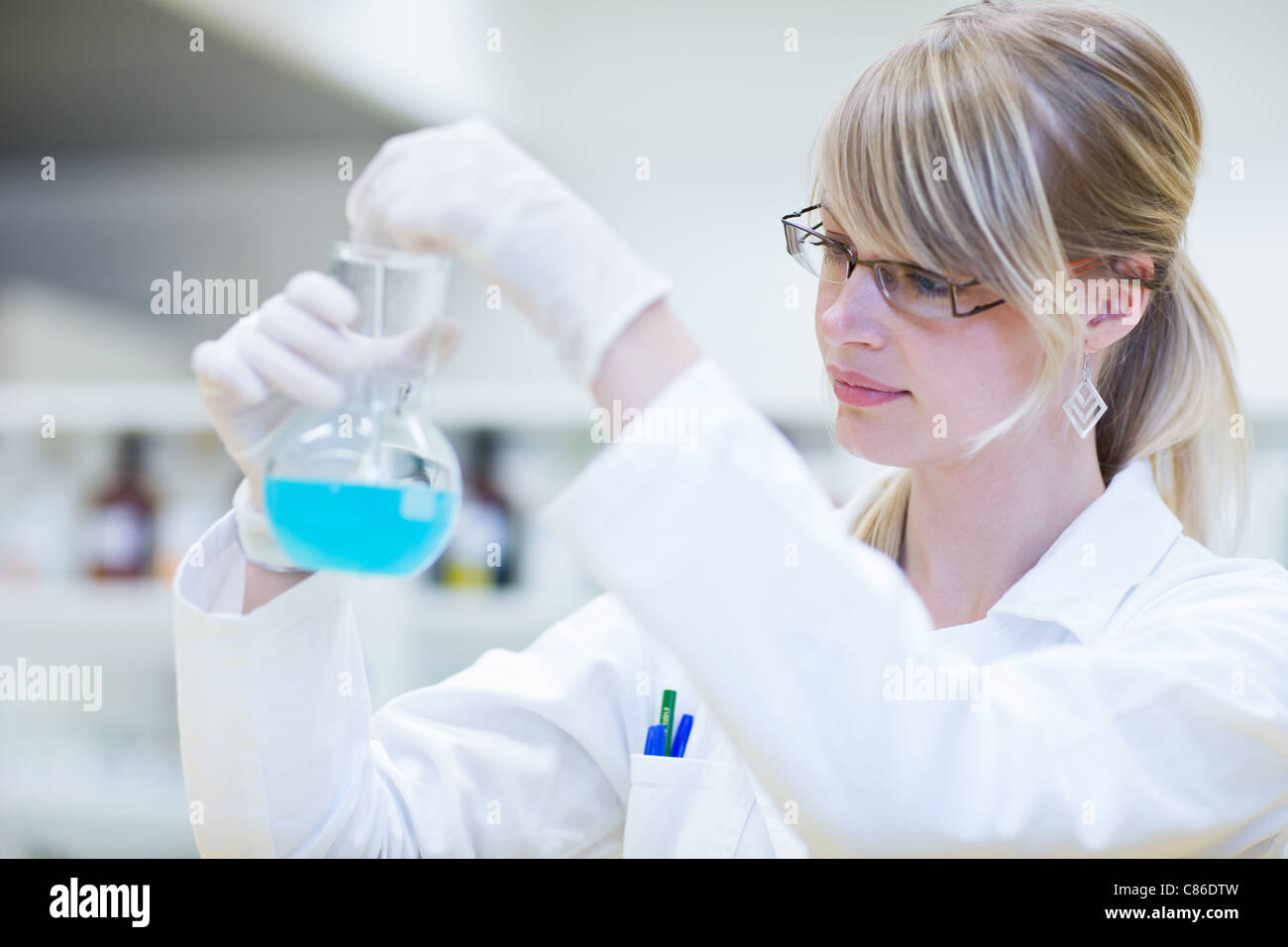 Portrait of a female researcher in a chemistry lab/laboratory (color ...