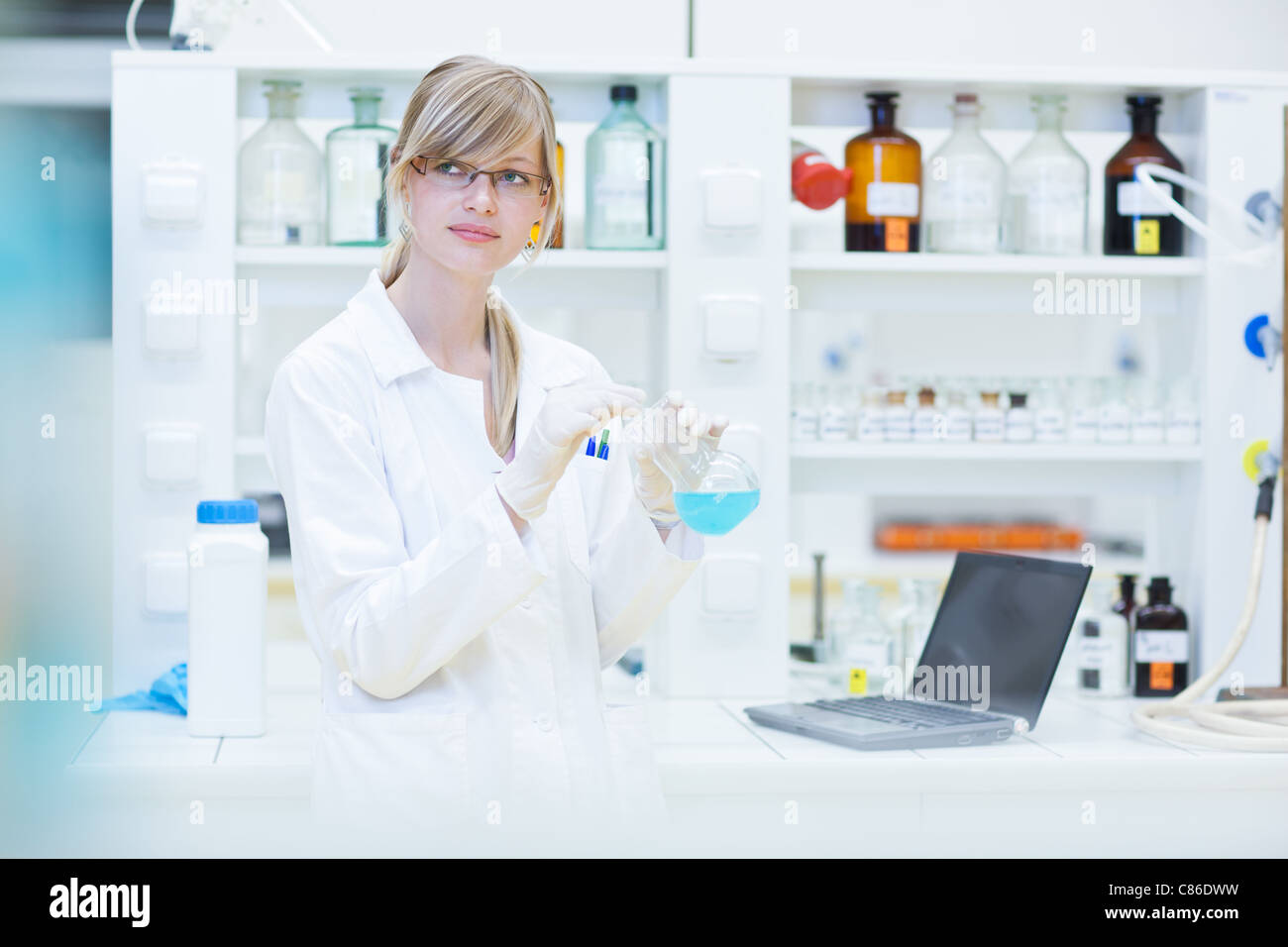 Portrait of a female researcher in a chemistry lab/laboratory (color ...