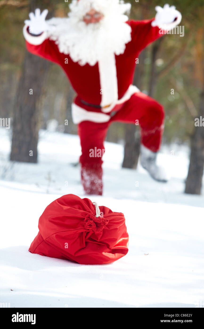 Santa Claus running to his sack lost in winter wood Stock Photo - Alamy