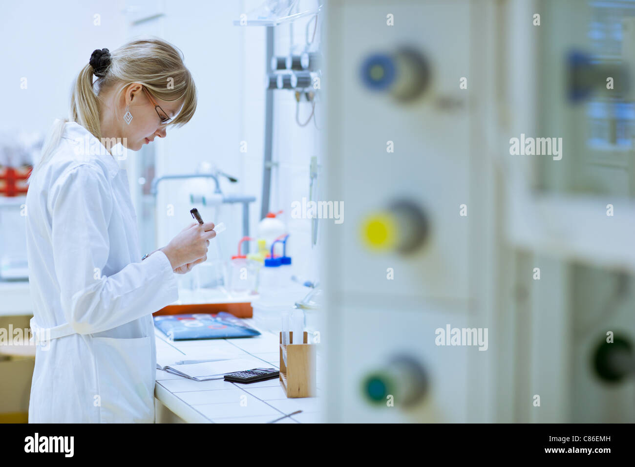 Portrait of a female researcher in a chemistry lab/laboratory (color ...