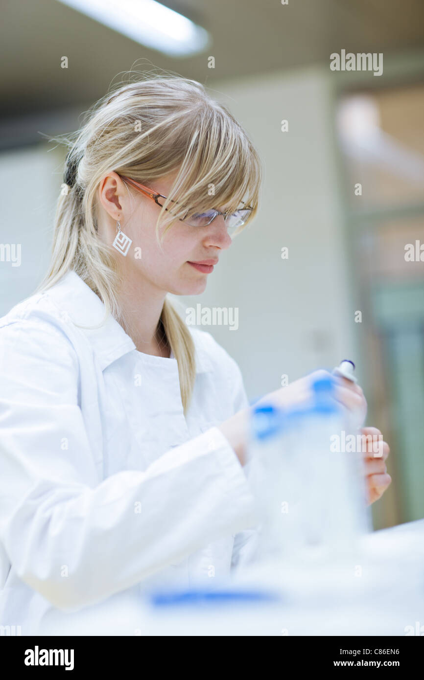 Portrait of a female researcher in a chemistry lab/laboratory (color ...