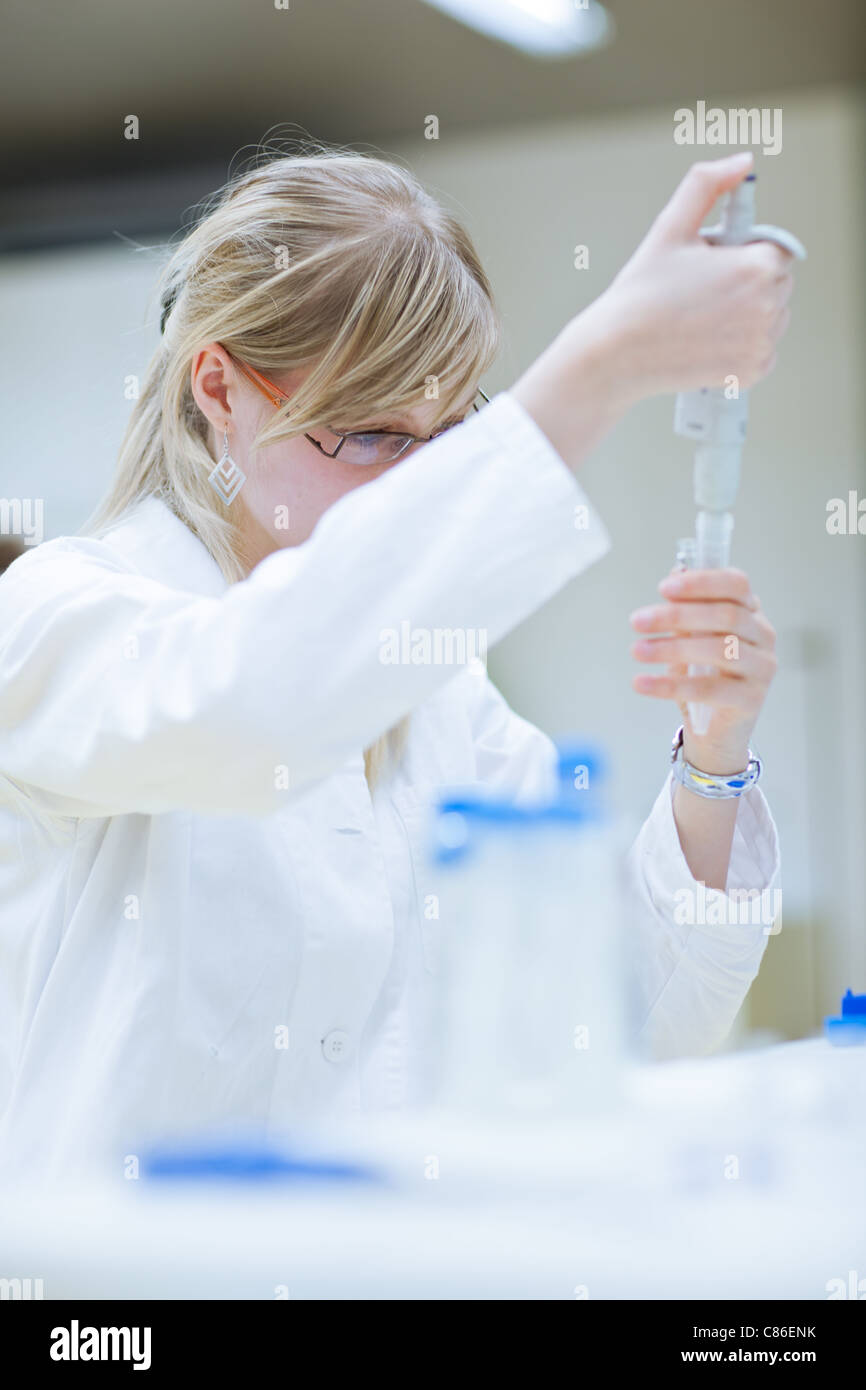 Portrait of a female researcher in a chemistry lab/laboratory (color ...